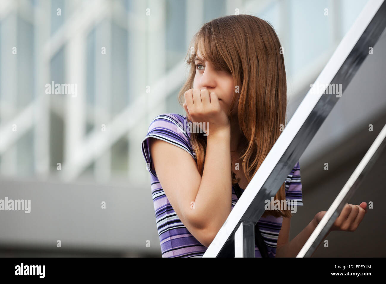 Sad young girl against a school building Stock Photo - Alamy