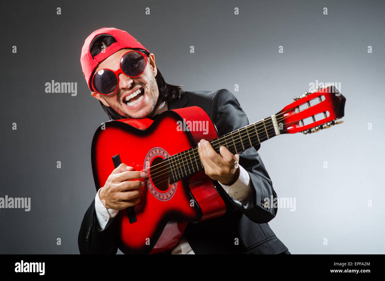 Funny guitar player in studio Stock Photo - Alamy