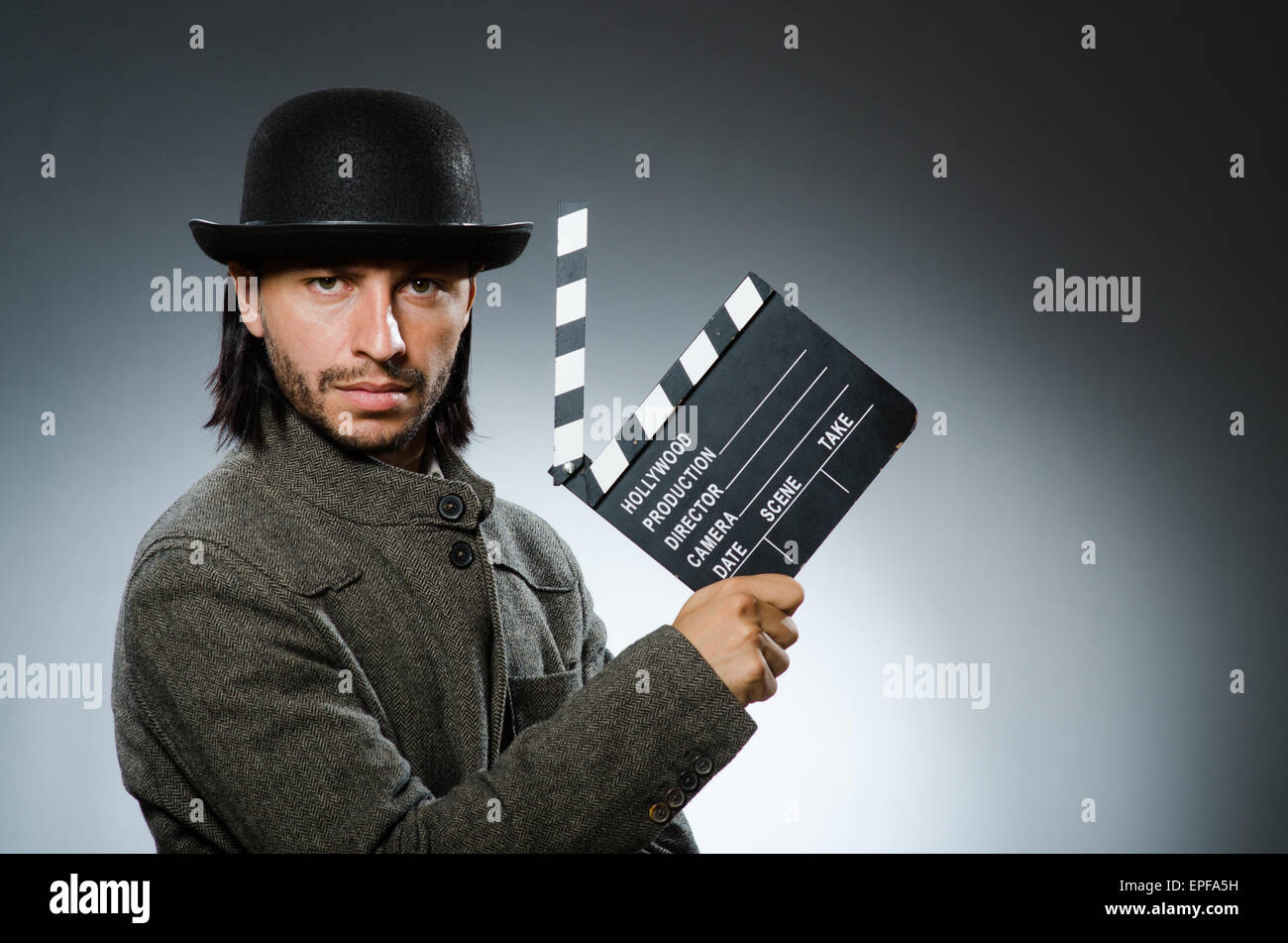 Man with movie clapperboard and hat Stock Photo - Alamy