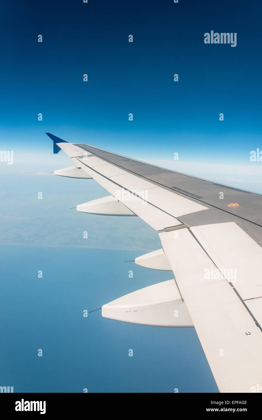 Airplane wing out of window Stock Photo - Alamy