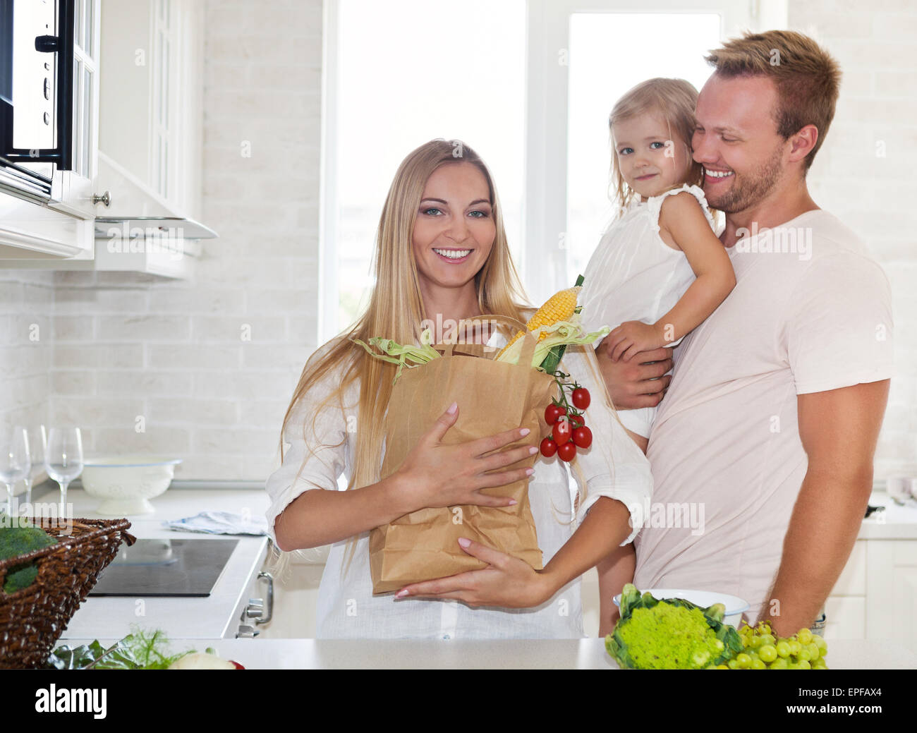 Family cooking in a modern kitchen setting Stock Photo - Alamy