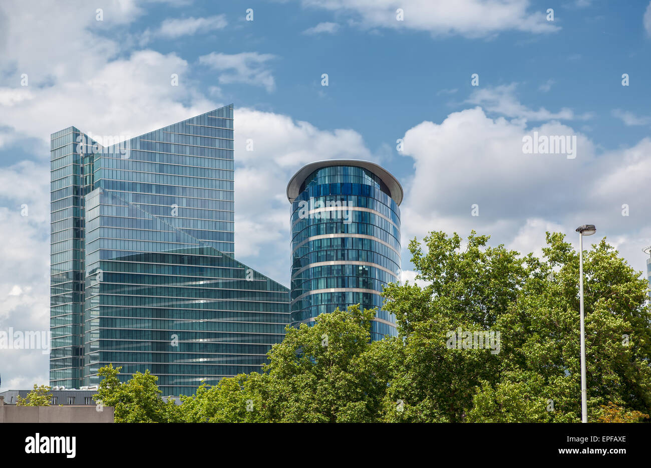 Modern building near park with green trees Stock Photo - Alamy