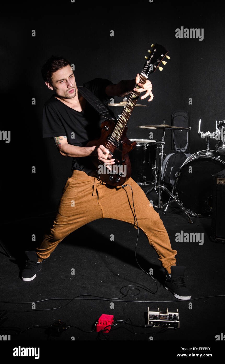 Man with guitar during concert Stock Photo - Alamy