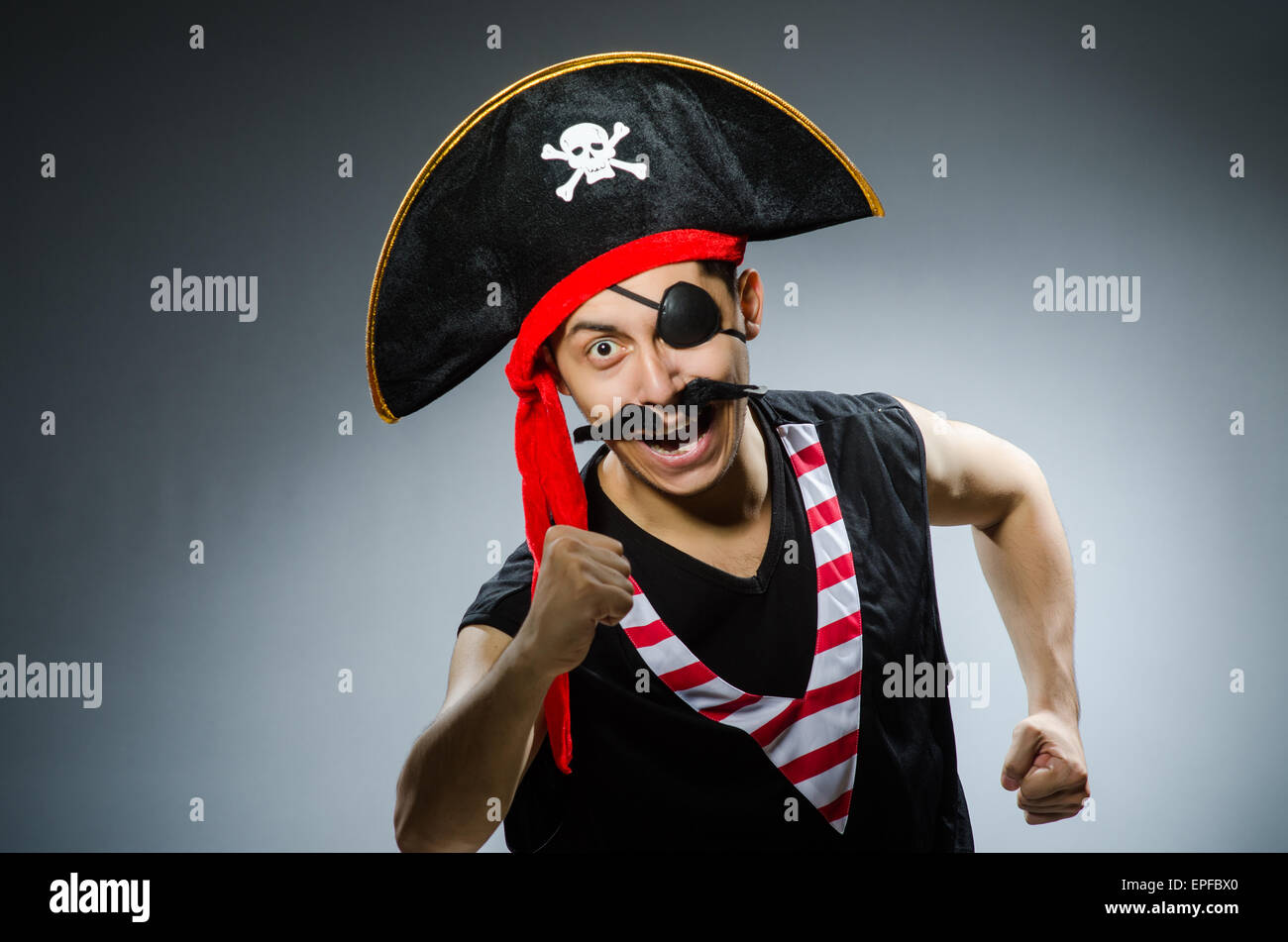 Funny pirate in the dark studio Stock Photo - Alamy