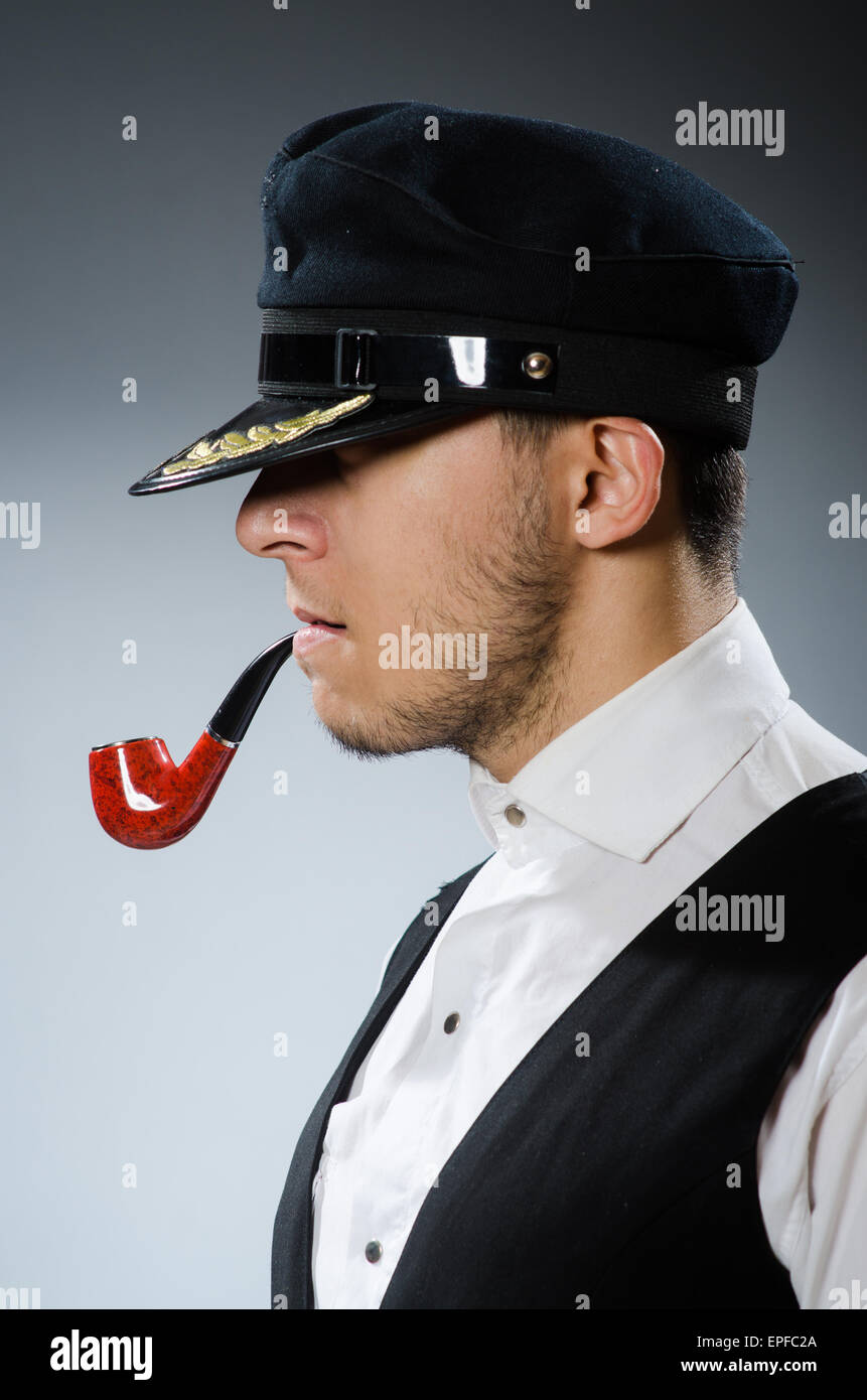 Captain smoking pipe with tobacco Stock Photo - Alamy