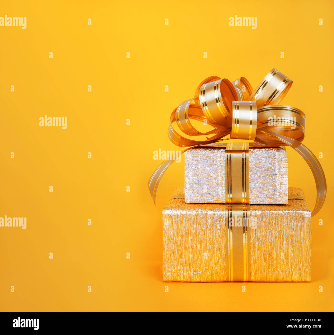 Beautiful Gift box in gold wrapping paper on abstract background Stock ...