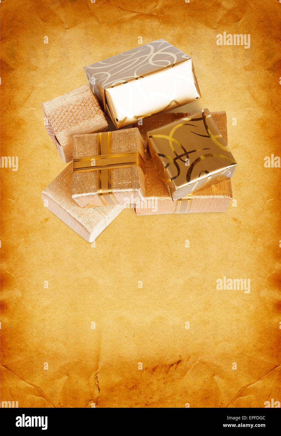 Gift box in gold wrapping paper on vintage cardboard background Stock ...