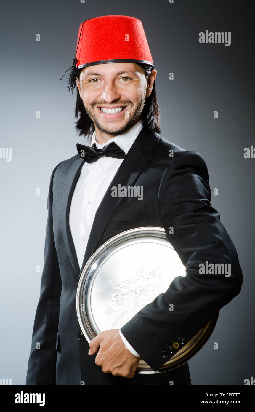 Waiter wearing traditional turkish hat Stock Photo - Alamy