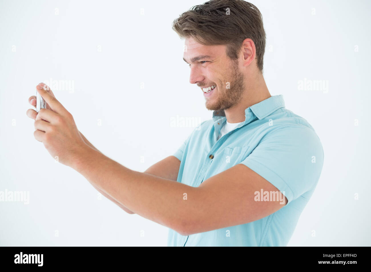 Happy man looking at his mobile phone Stock Photo - Alamy