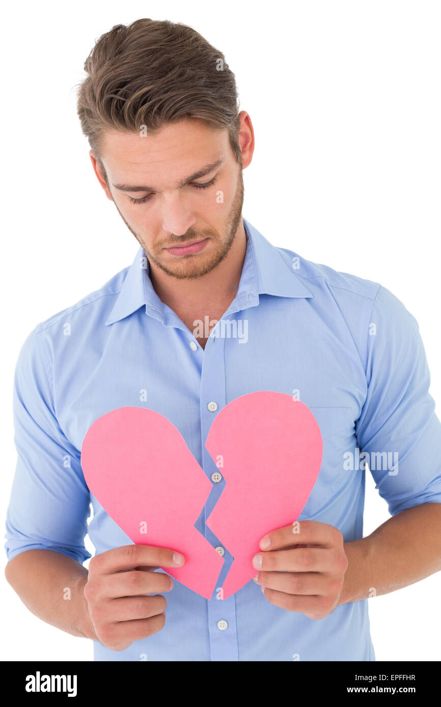 Young man holding broken heart Stock Photo - Alamy