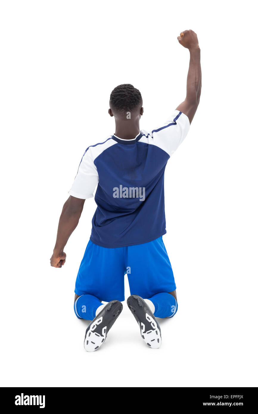 Full length of fit football player cheering Stock Photo - Alamy