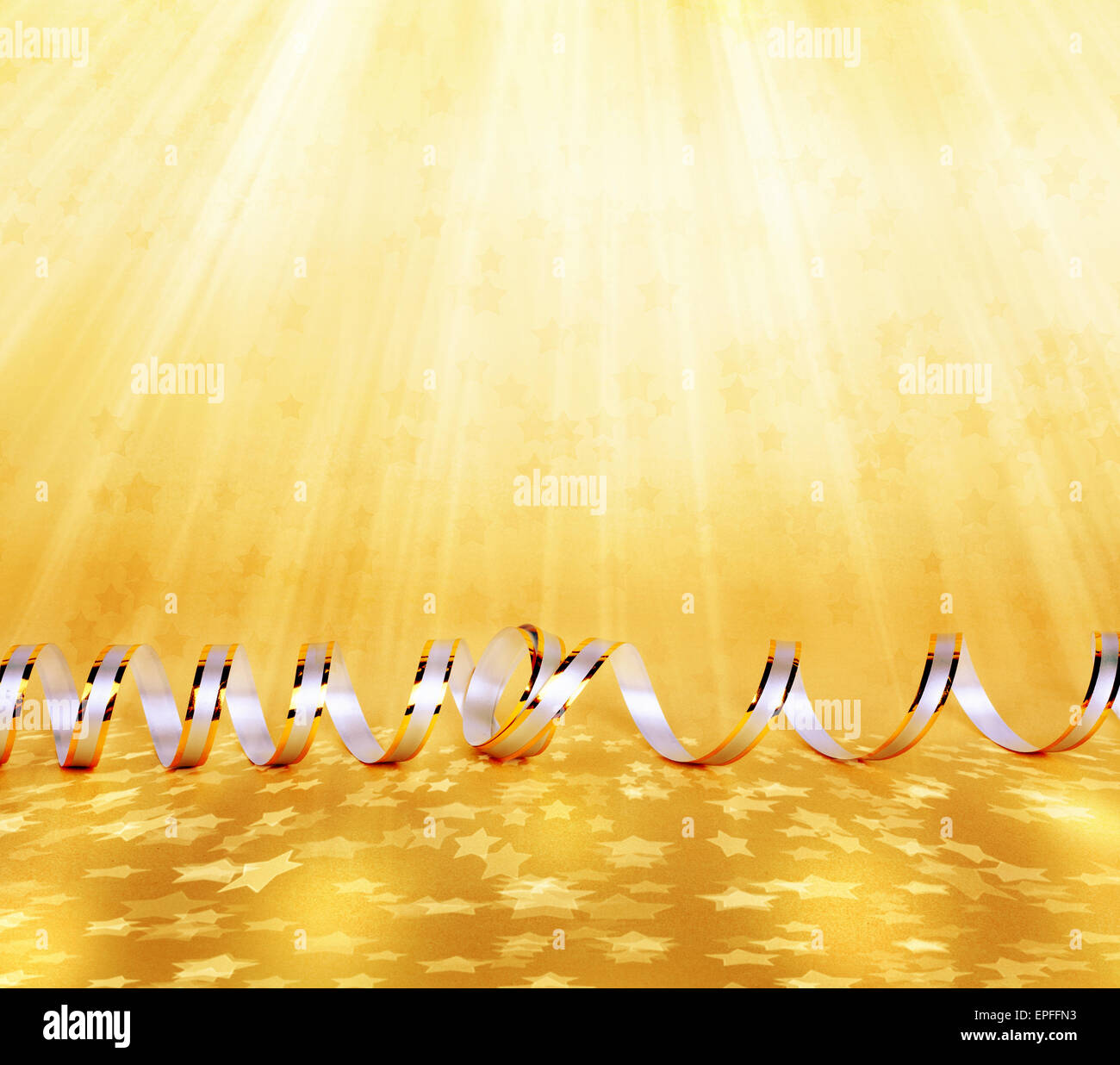 Beautiful ribbon streamers on a gold sparkling abstract background ...