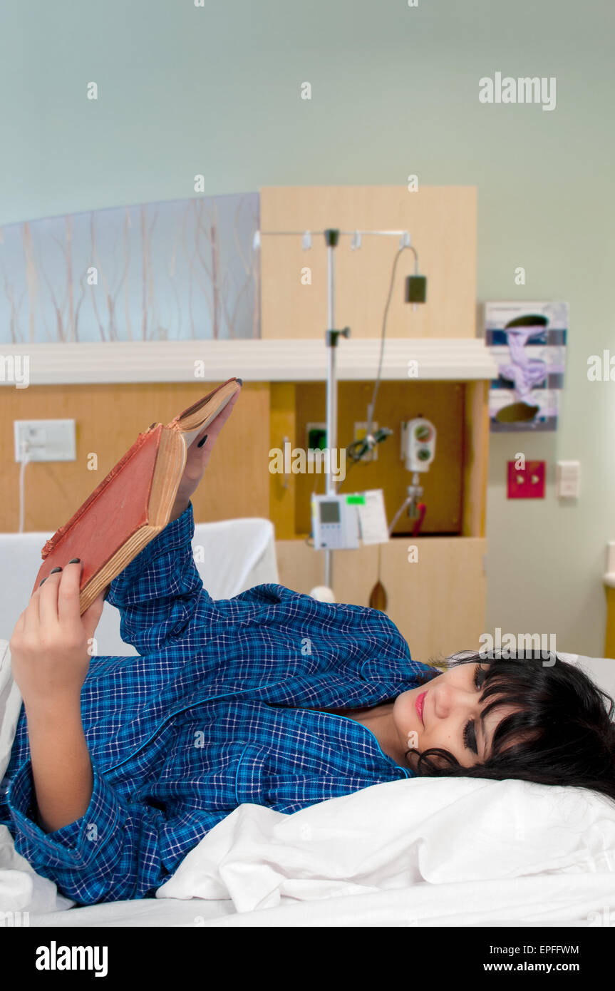 Woman Reading in Bed Stock Photo - Alamy