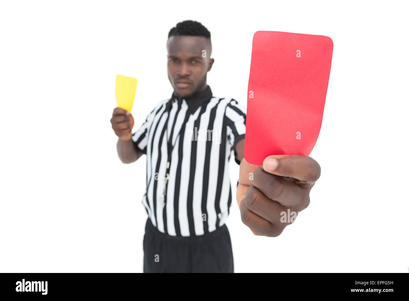 Serious referee showing yellow and red card Stock Photo - Alamy
