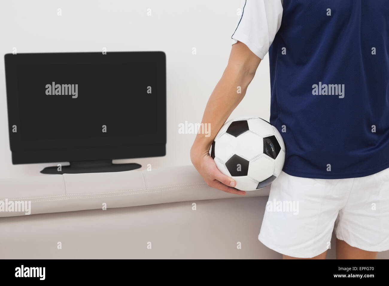 Soccer fan watching tv Stock Photo - Alamy