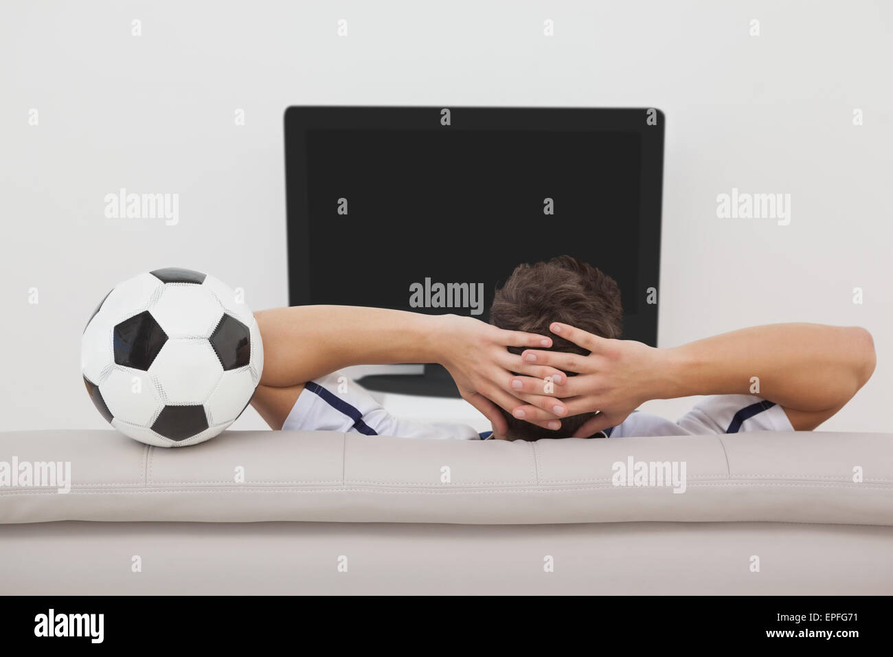 Soccer fan watching tv Stock Photo - Alamy