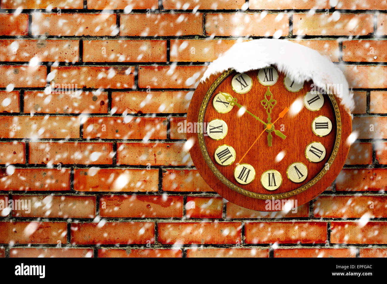 Snow-covered clock on background of old brick wall Stock Photo - Alamy