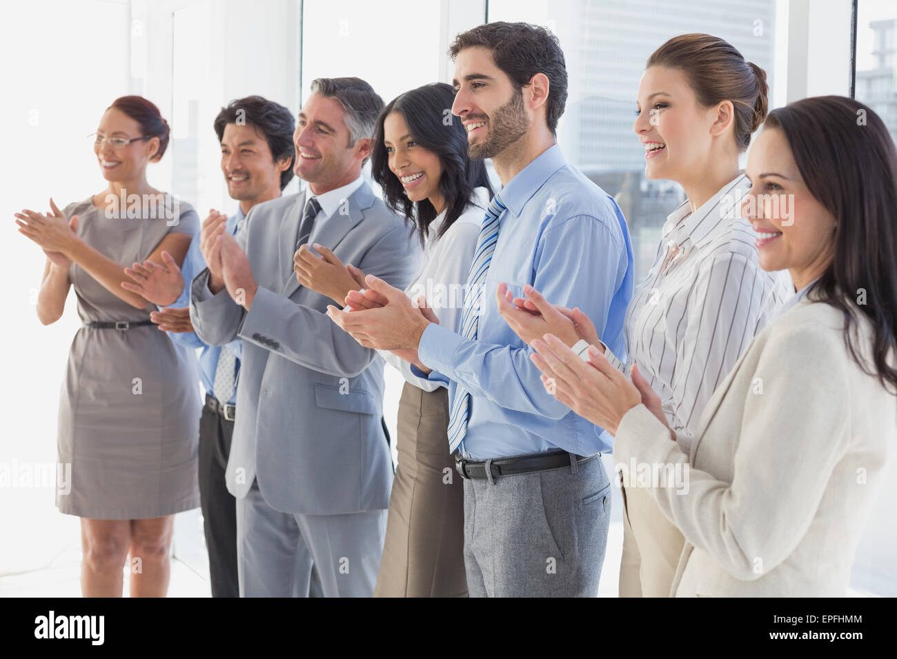 Applauding workers smiling and cheerful Stock Photo - Alamy