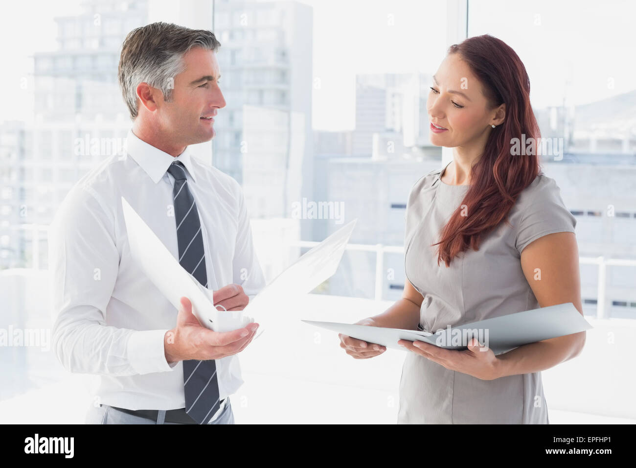 Business people smiling and talking Stock Photo - Alamy