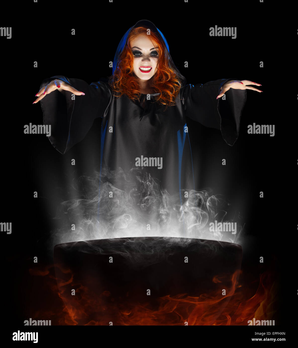 Young witch with cauldron isolated Stock Photo - Alamy