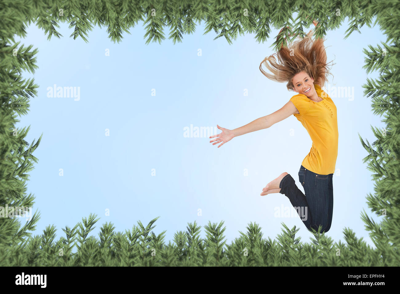 Pretty young woman jumping for joy Stock Photo - Alamy