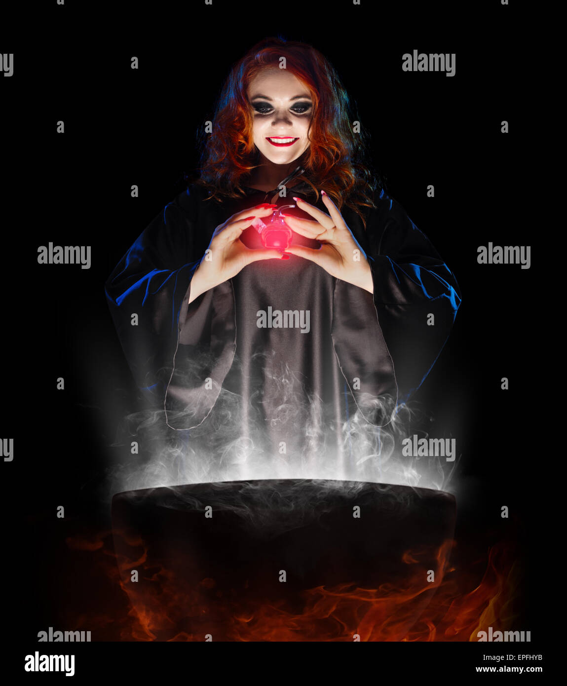Young witch with potion and cauldron isolated Stock Photo - Alamy