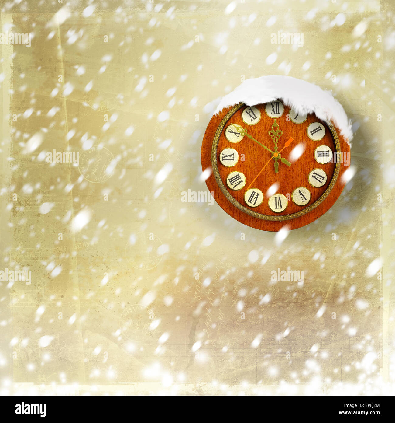Snow-covered clock on abstract gold background Stock Photo - Alamy
