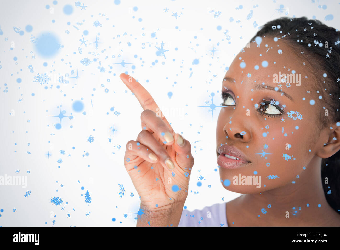 Close up of woman pointing at something next to her on a white ...