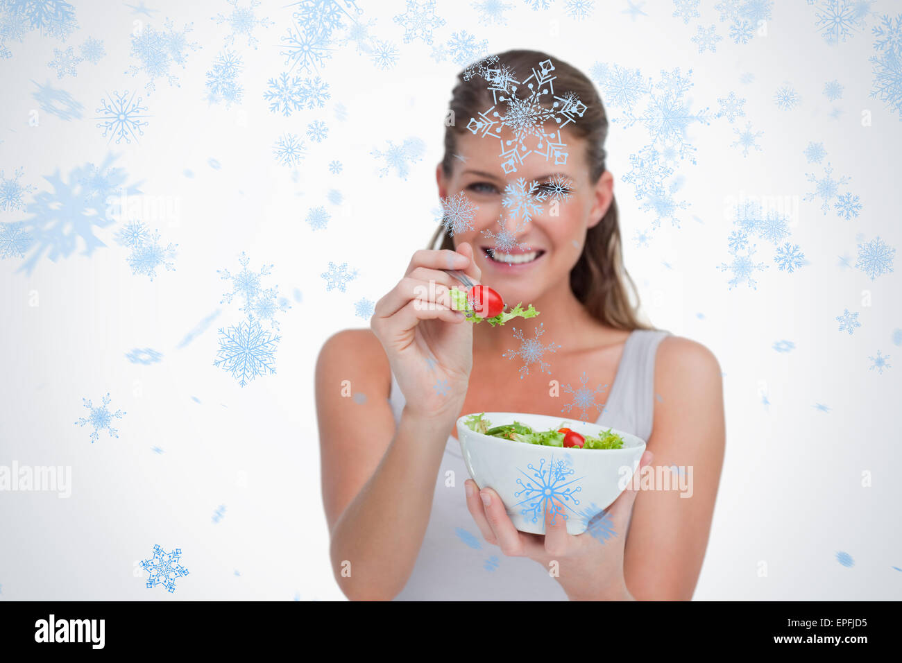 Smiling woman eating a salad Stock Photo - Alamy