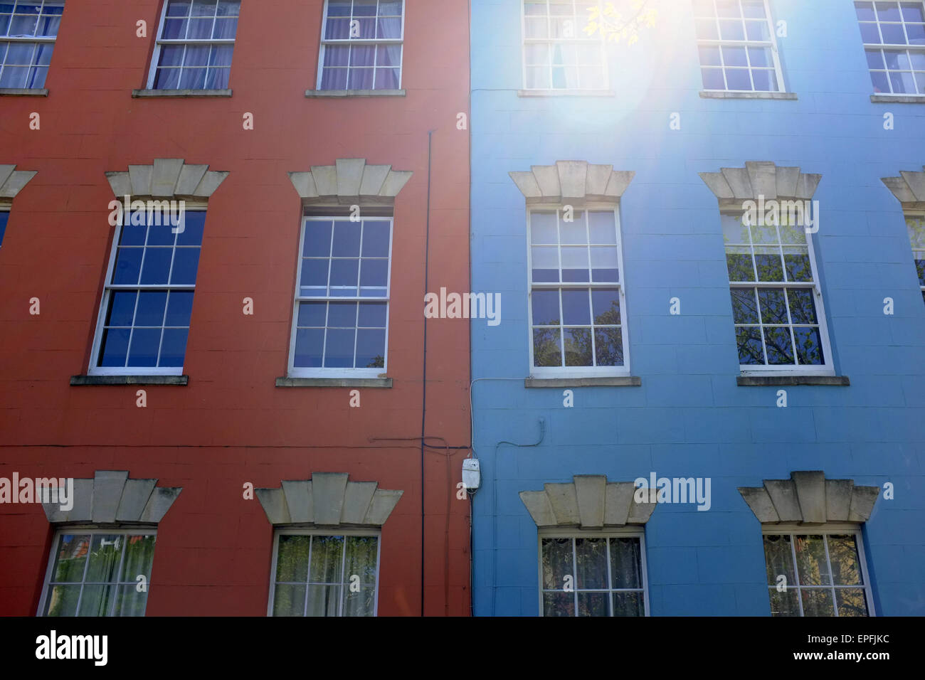 Terraced properties painted blue and red in Bristol Stock Photo - Alamy