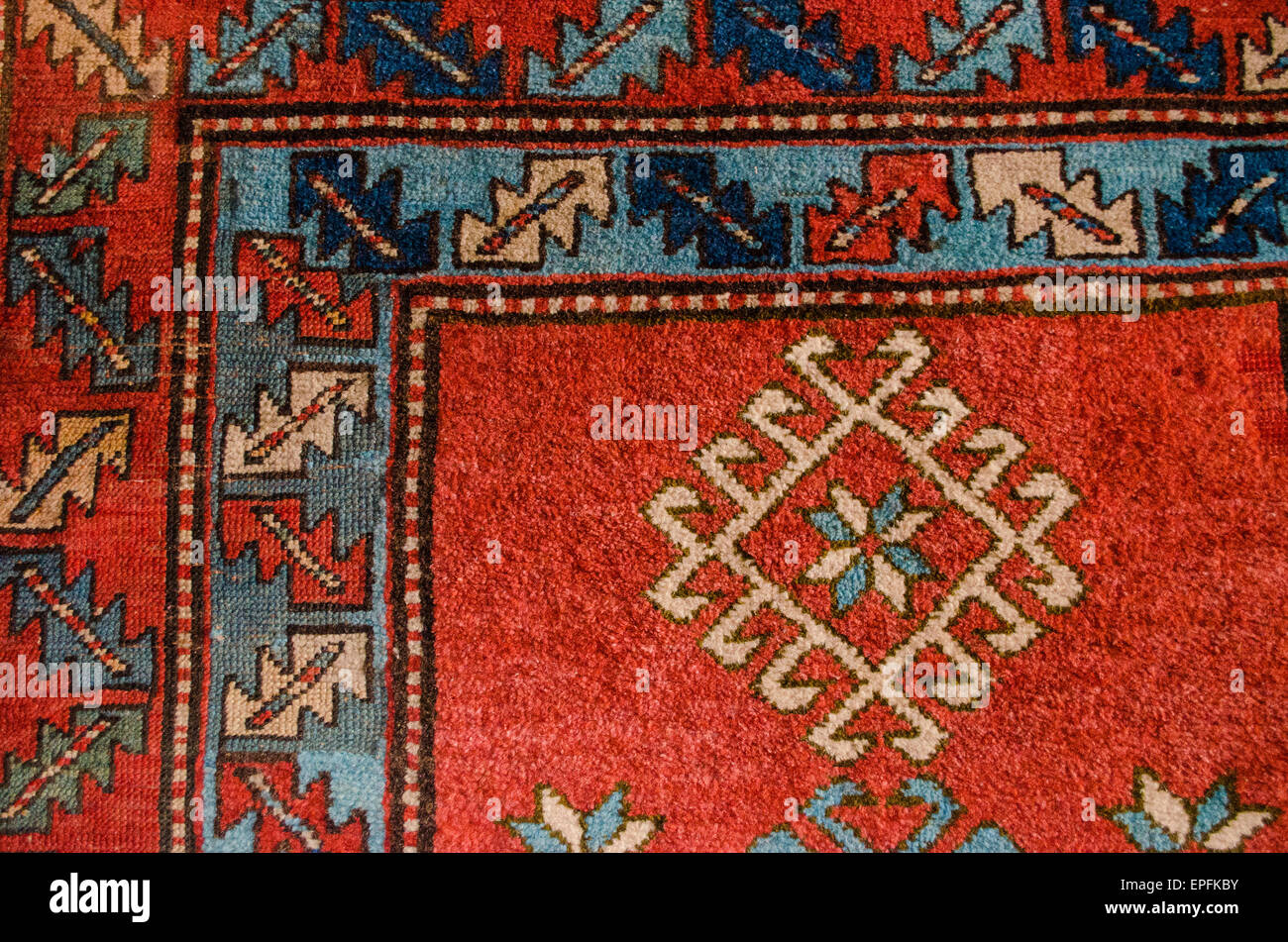 Angle with pattern ancient Armenian red woolen carpet Stock Photo - Alamy