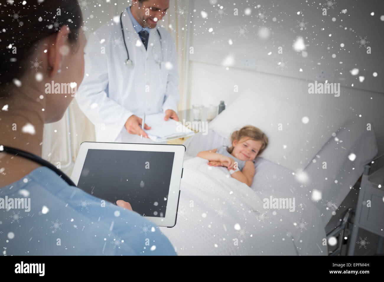 Composite image of doctors attending sick girl Stock Photo - Alamy