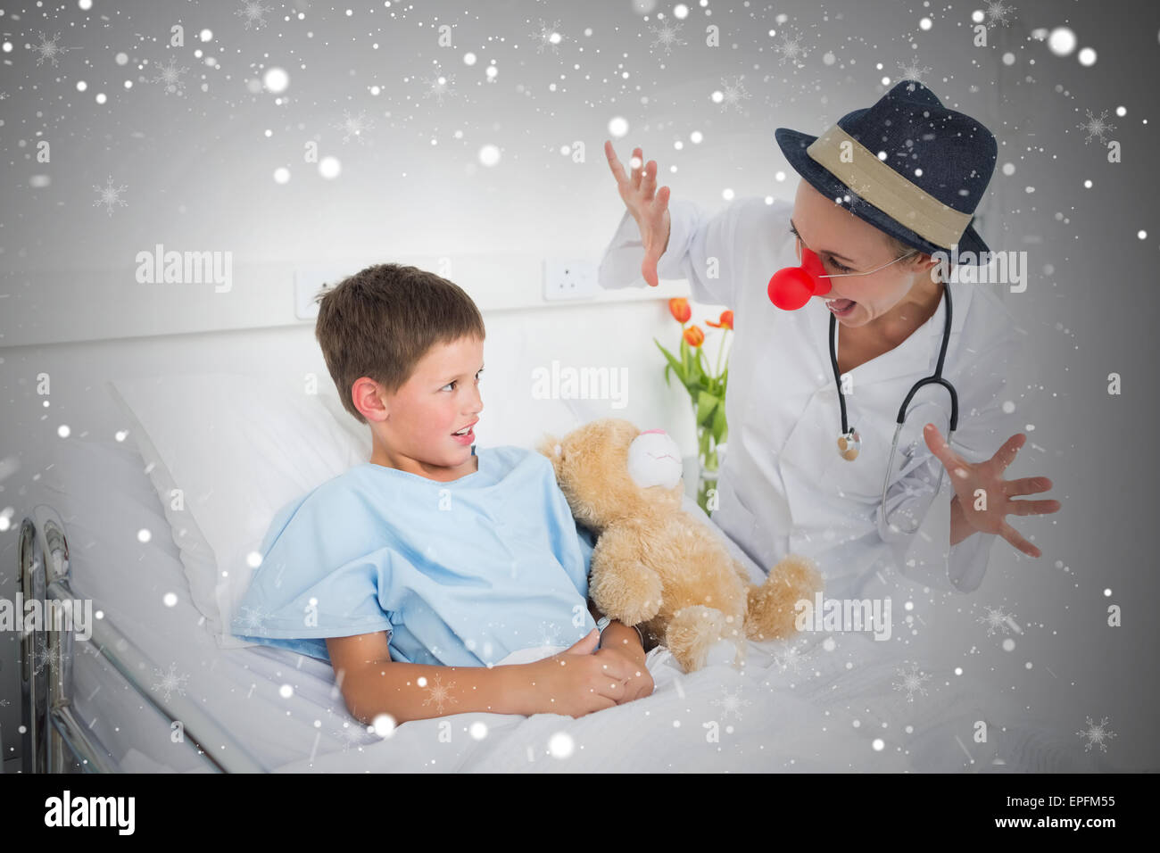 Doctor in clown costume entertaining ill boy in hospital Stock Photo ...