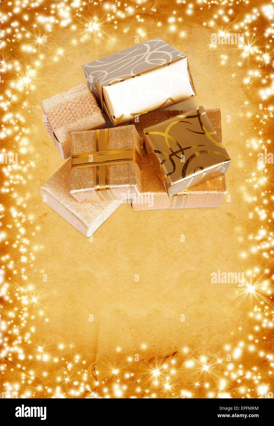 Gift box in gold wrapping paper on vintage cardboard background with ...