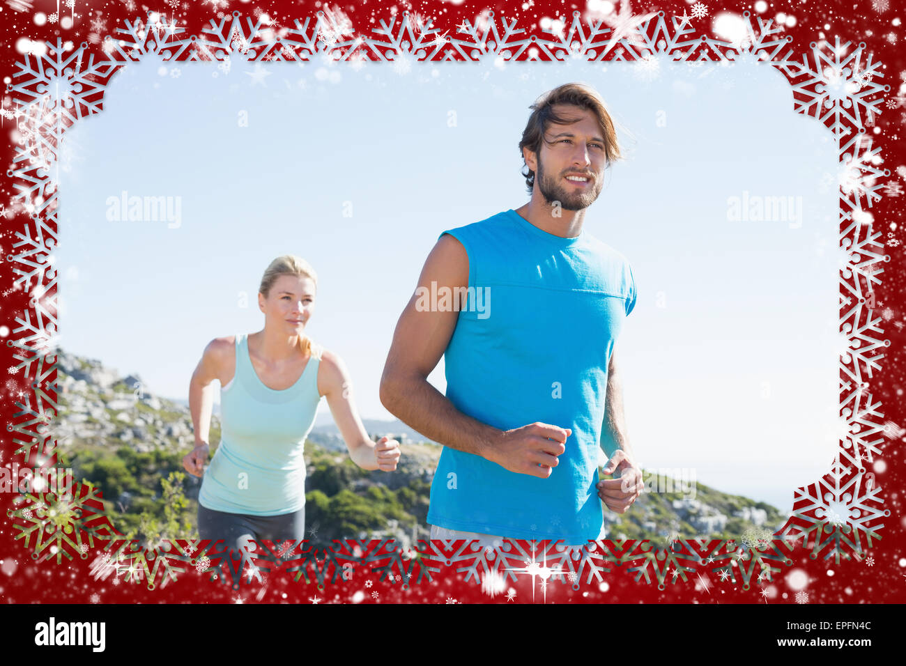 Fit couple jogging through countryside Stock Photo - Alamy
