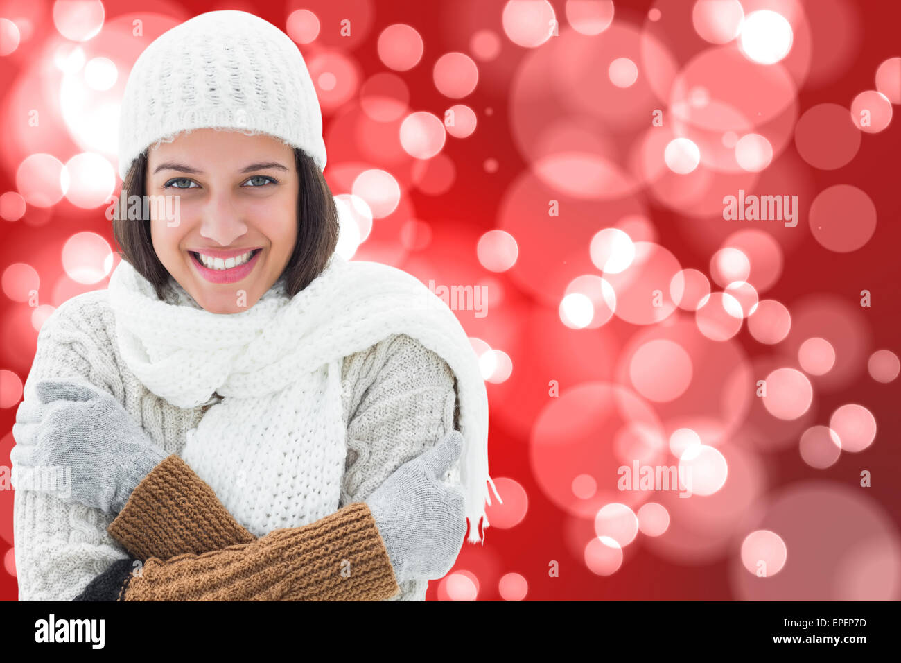 Composite image of brunette in warm clothing Stock Photo - Alamy