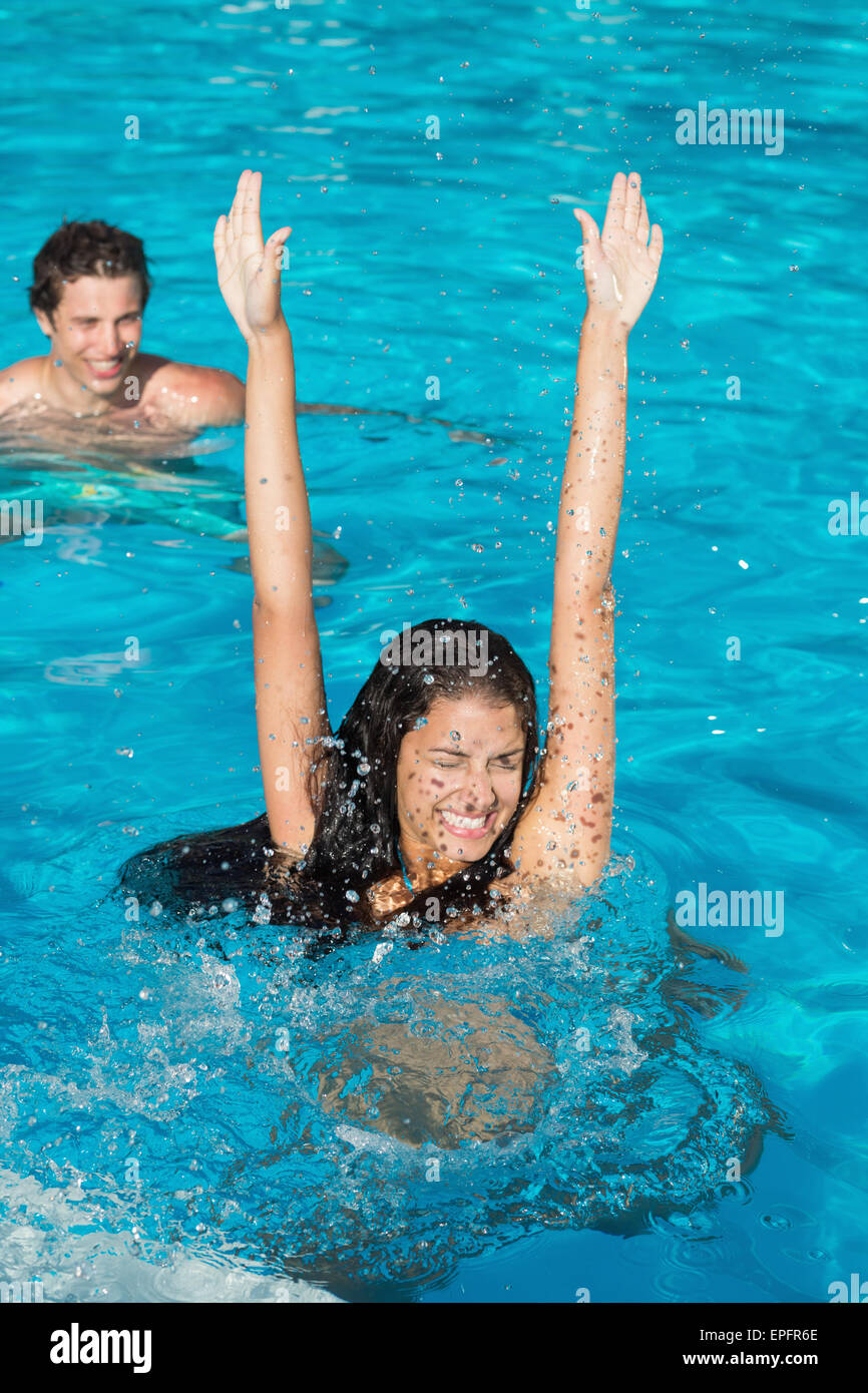 Couple playing in swimming pool Stock Photo - Alamy