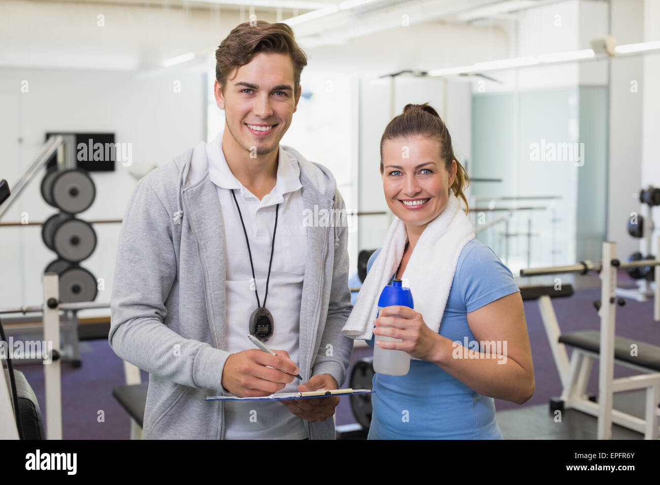 Personal trainer and client smiling at camera Stock Photo - Alamy