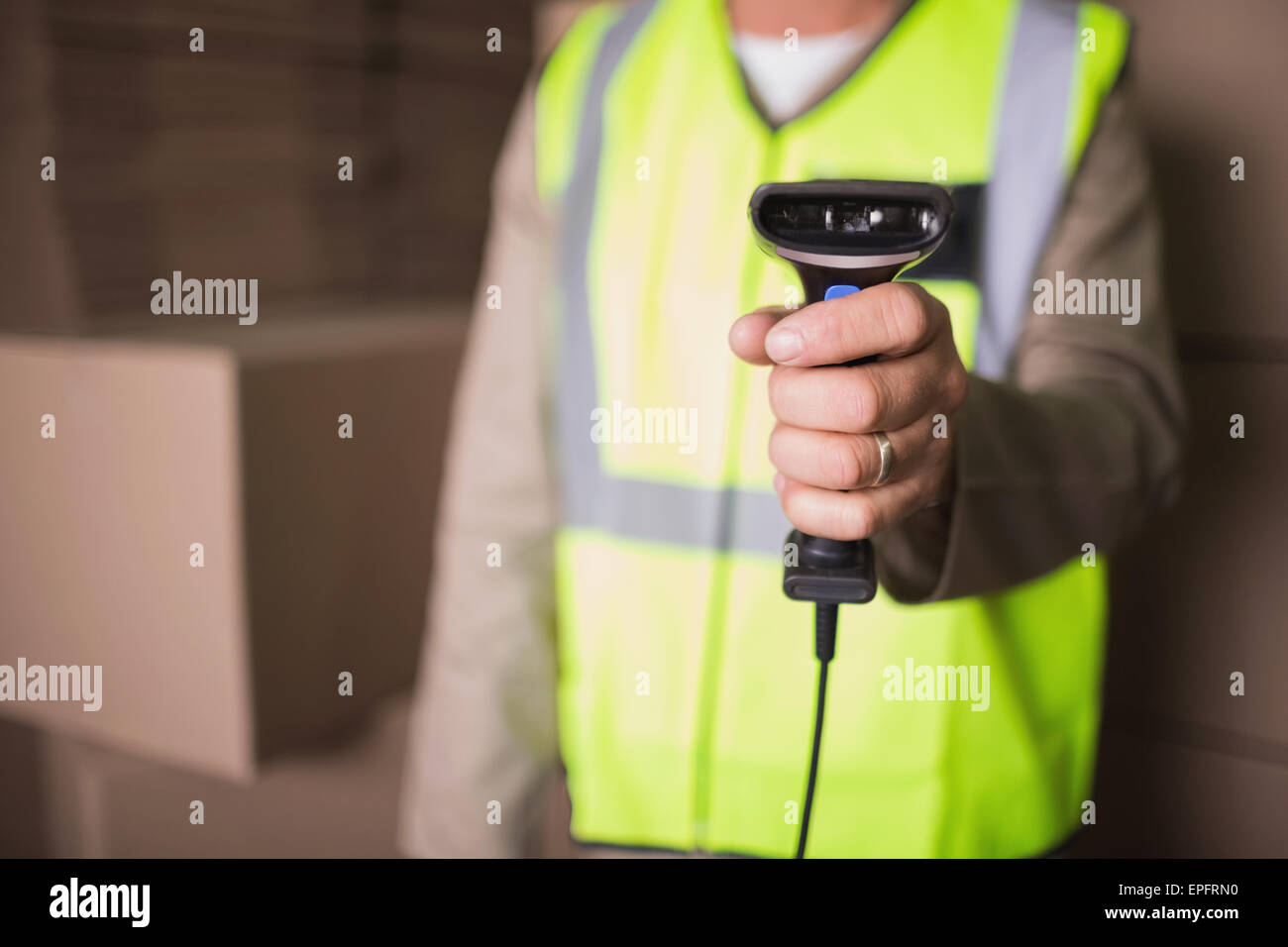 Mid section of worker with scanner in warehouse Stock Photo - Alamy