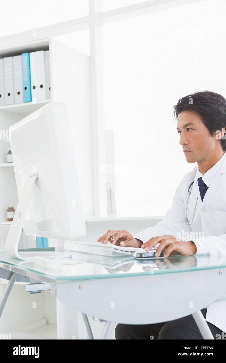 Serious doctor using the computer Stock Photo - Alamy