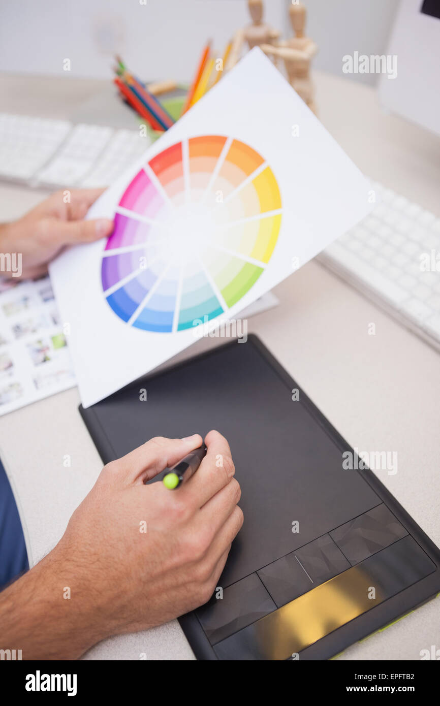 Designer using graphics tablet and colour wheel Stock Photo - Alamy