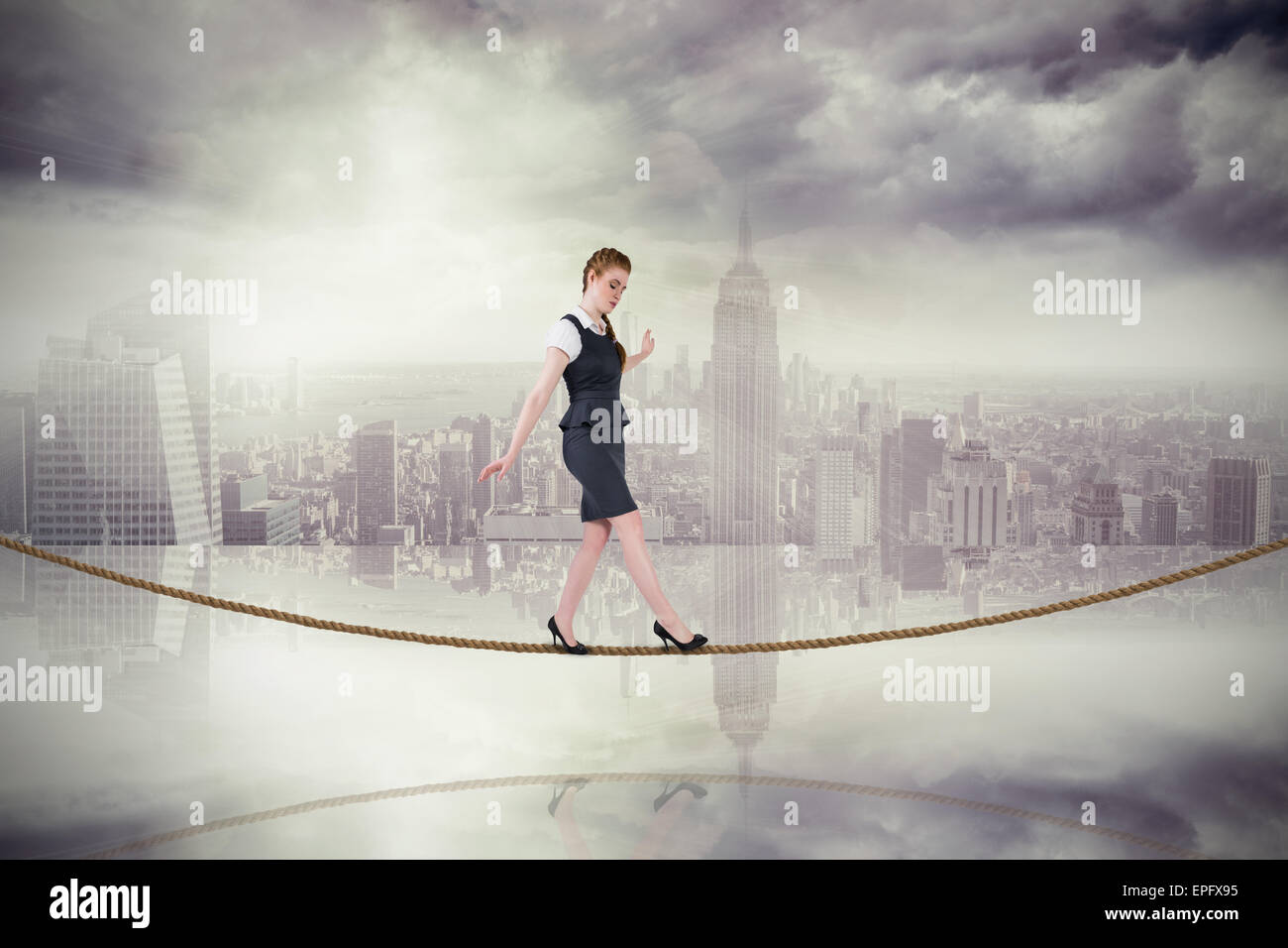 Composite image of businesswoman doing a balancing act on tightrope ...