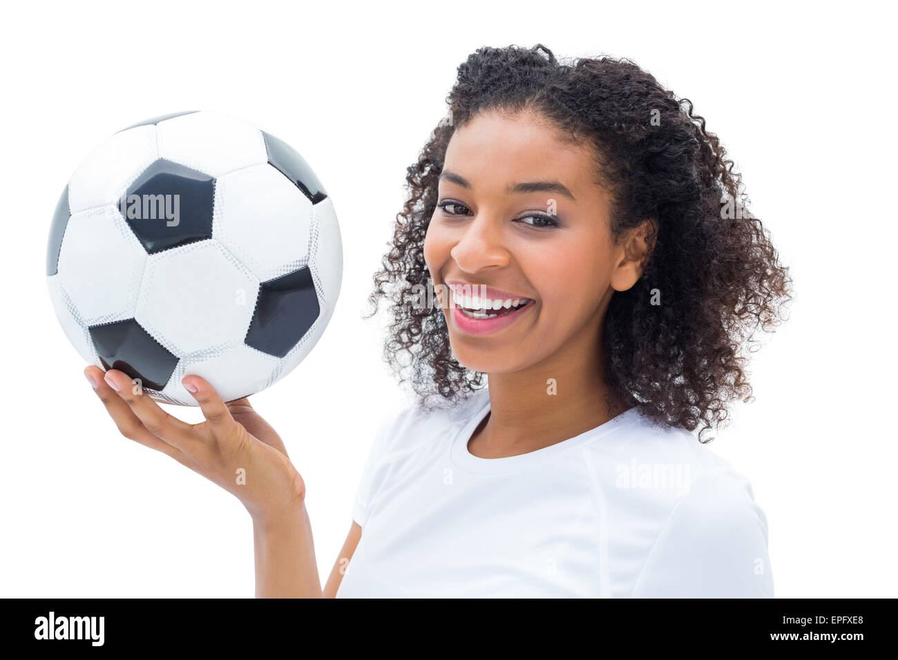 Pretty football fan in white holding ball smiling at camera Stock Photo ...
