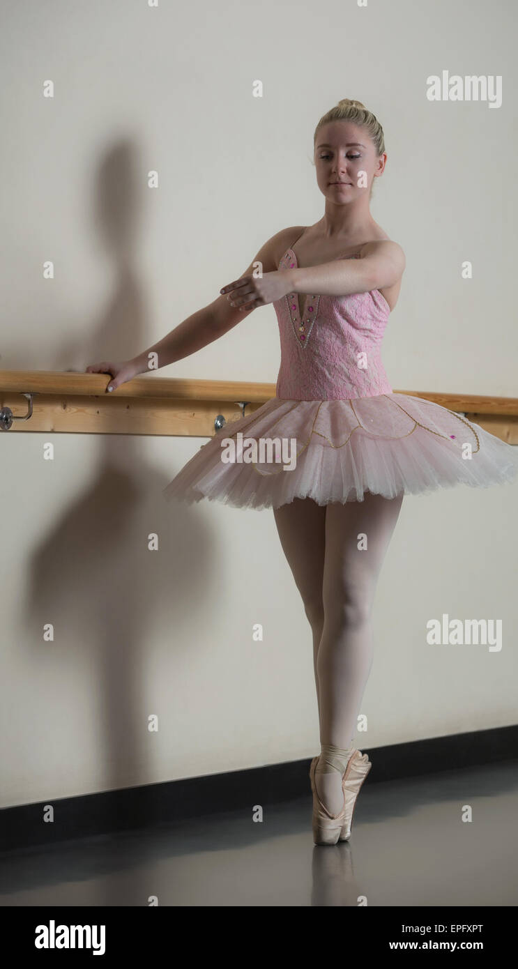 Beautiful ballerina standing en pointe holding barre Stock Photo - Alamy