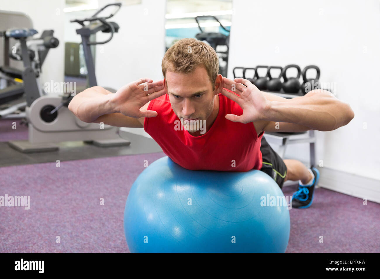 Fit man working his core on exercise ball Stock Photo - Alamy