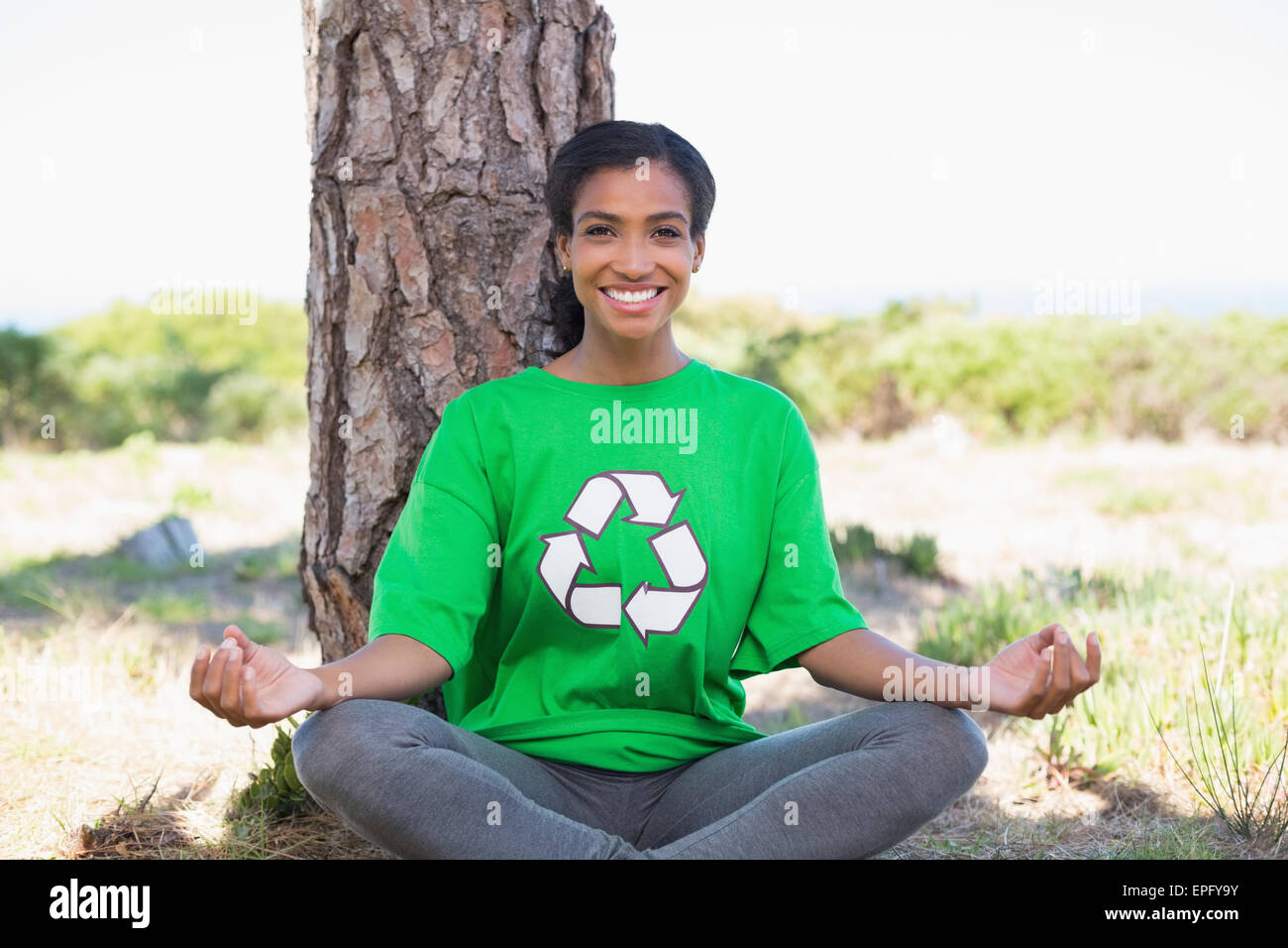 Pretty environmental activist doing yoga by a tree Stock Photo - Alamy