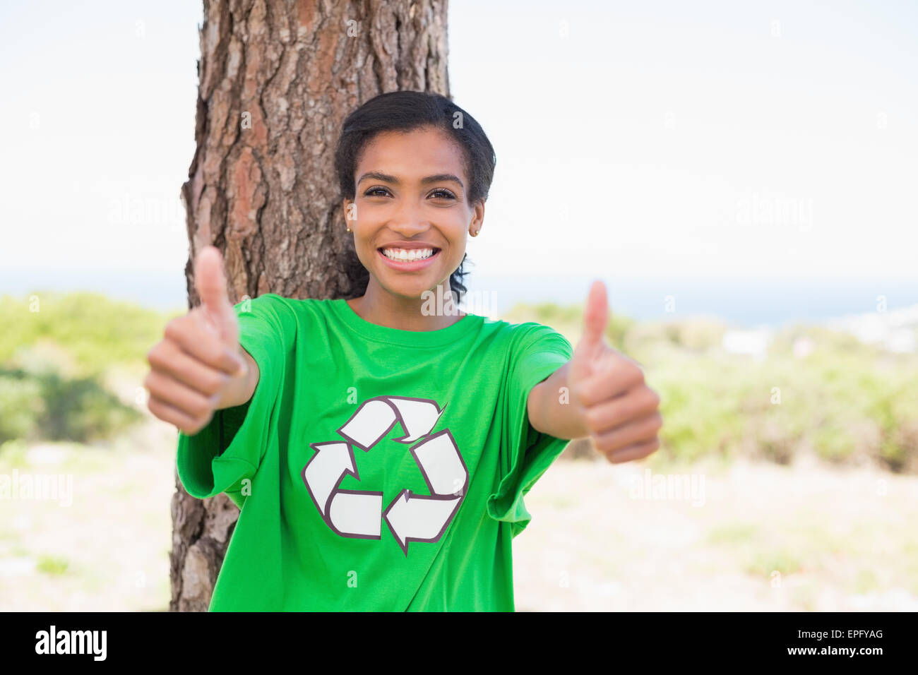 Pretty environmental activist smiling at camera showing thumbs up Stock ...