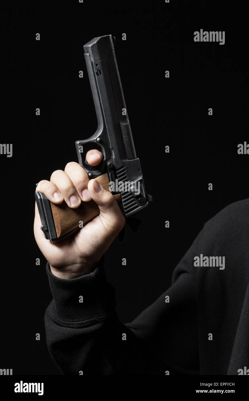 male hand with gun isolated on black background Stock Photo - Alamy