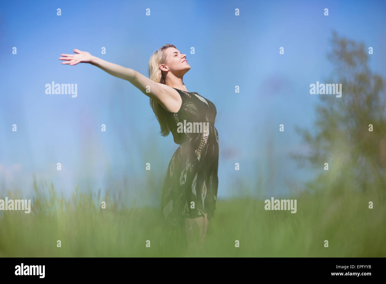 Pretty blonde in sundress standing hi-res stock photography and images ...