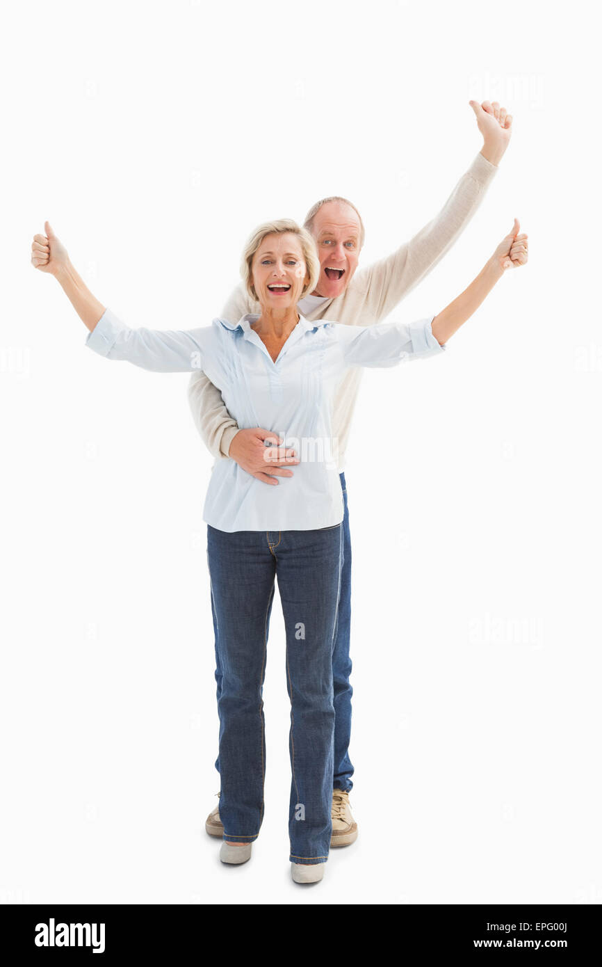 Happy mature couple cheering at camera Stock Photo - Alamy